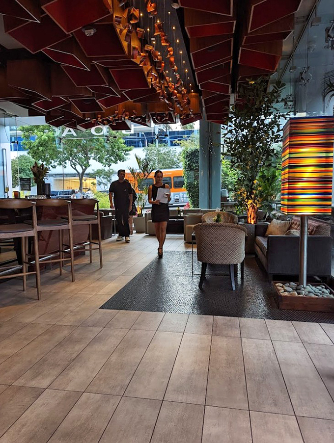 Modern elegance meets California cool in BOA's interior, where dramatic ceiling elements and lush greenery create the perfect backdrop for serious steak business.