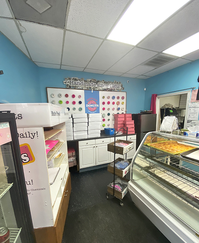 Inside, the cheerful blue walls and colorful display board create the perfect backdrop for serious donut decisions. Life's big questions happen here.