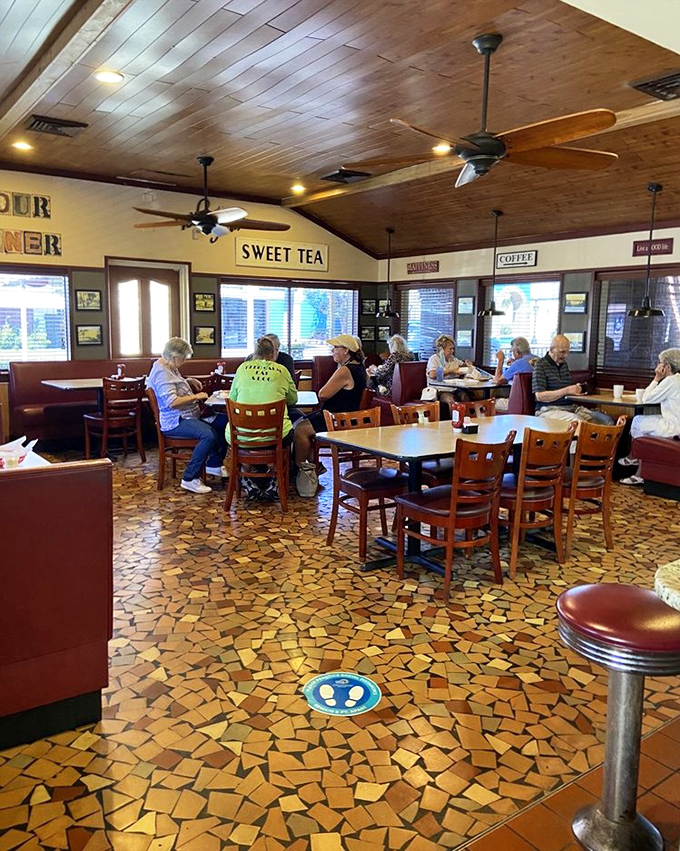 Inside, the warm wooden ceiling and distinctive mosaic floor create that perfect diner atmosphere where conversations flow as freely as the coffee.