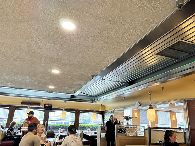 Inside, the warm glow of pendant lights illuminates comfortable booths where countless Philadelphia stories have unfolded over cups of bottomless coffee.