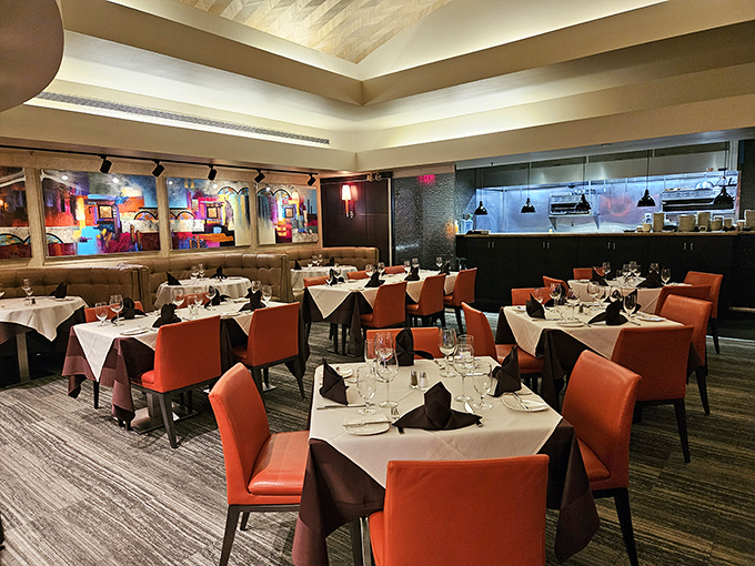 Coral-hued chairs and crisp white tablecloths create the perfect stage for culinary drama to unfold. This isn't just dinner&mdash;it's theater.