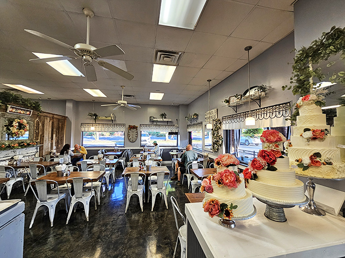 Inside, wedding cakes stand like edible monuments while ceiling fans lazily spin above metal chairs that have witnessed countless birthday celebrations and first dates.