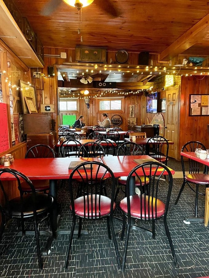 Step inside and you're wrapped in the warm embrace of knotty pine walls, string lights, and decades of pizza perfection. The dining room feels like coming home.