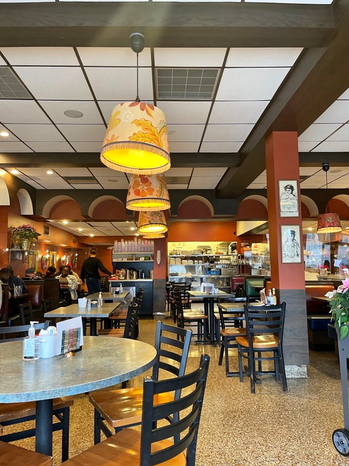 Vintage-inspired pendant lamps cast a warm glow over the dining room, creating the perfect ambiance for serious breakfast contemplation.