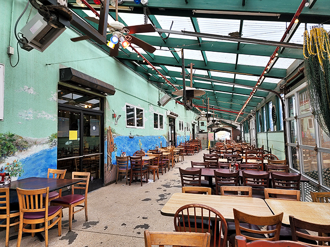 The sea-green patio dining area feels like eating inside a mermaid's sunroom, where every wooden chair has hosted thousands of satisfied seafood pilgrims.