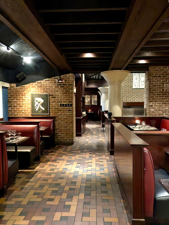 Step inside and discover dining rooms where exposed brick meets sophisticated comfort, creating atmosphere that's both rustic and refined.