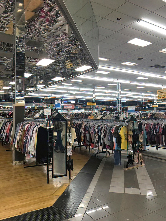 Mirrored ceilings create an optical illusion of endless racks, as if your bargain-hunting dreams have manifested into reality.