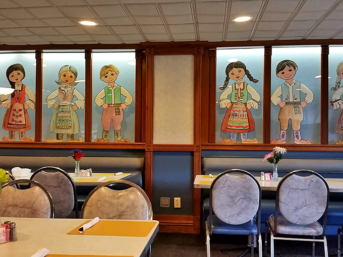 Folk art figures in traditional Serbian attire watch over diners, silently promising authentic flavors that transcend the humble surroundings.