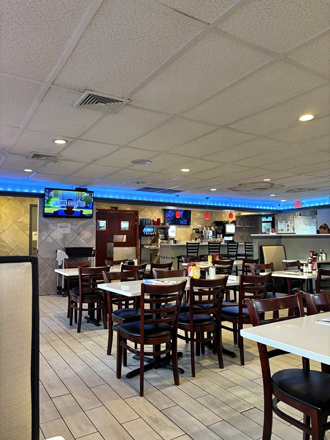 Inside, the blue accent lighting and classic diner setup create that perfect "everybody knows your name" vibe without trying too hard.