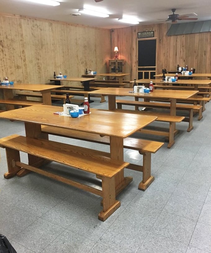 Rustic wooden tables and benches create a homey, camp-like atmosphere where strangers become friends over plates of comfort food.