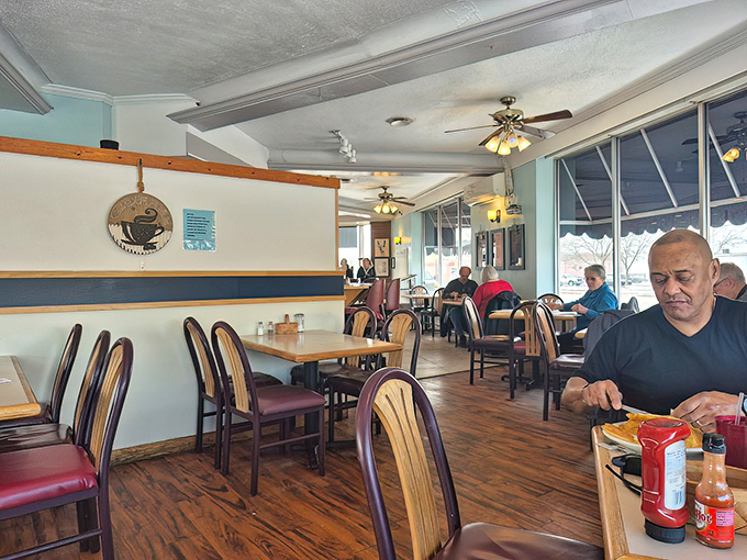 Warm wood tones and comfortable seating create the perfect backdrop for morning conversations that flow as freely as the coffee.