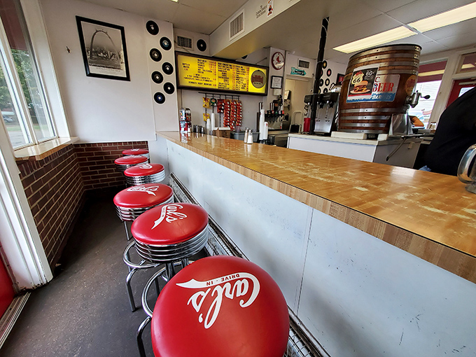 These cherry-red counter stools aren't just seats—they're front-row tickets to a culinary performance that's been running longer than most Broadway shows.