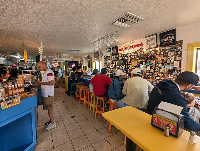 Inside, the walls tell stories of countless satisfied visitors, a visual guestbook where every sticker represents someone who fell in love with that famous chowder.