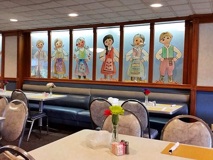 Folk art figures in traditional Serbian attire watch over diners, silently promising that what you're about to eat has roots deeper than most family trees.