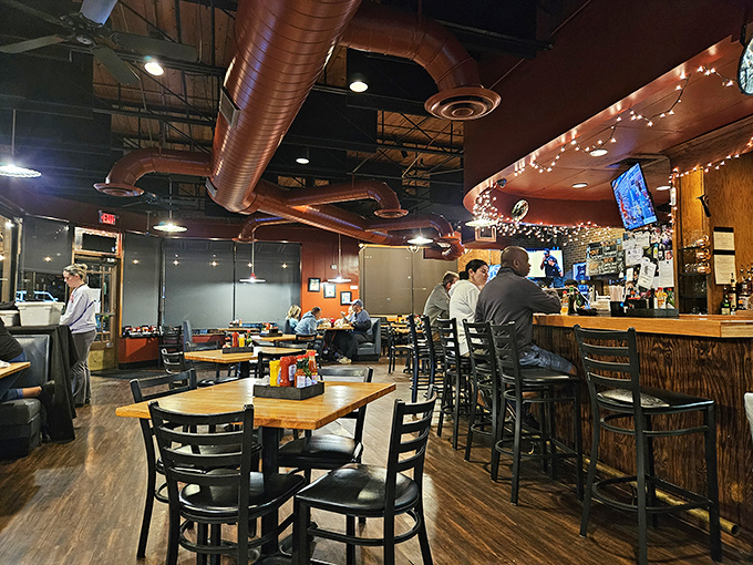 Inside Eddie's, copper ductwork meets warm wood tones, creating that perfect sweet spot between "neighborhood joint" and "hidden gem worth crossing town for."