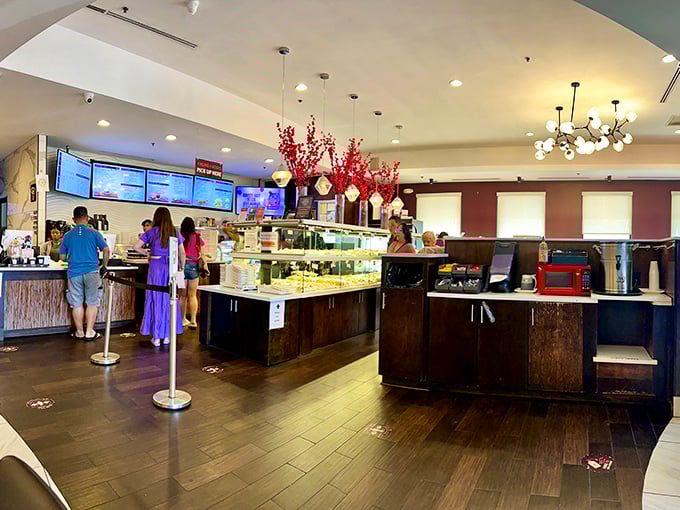 Inside Sweet Hut, modern elegance meets bakery wonderland, with display cases that make adults feel like kids with their noses pressed against the glass.