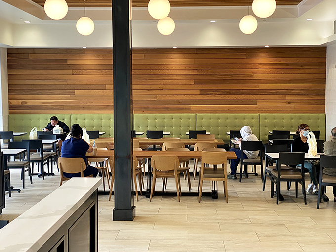 Modern meets cozy in Porto's dining area, where wooden accents and mint green booths create the perfect backdrop for pastry-induced euphoria.