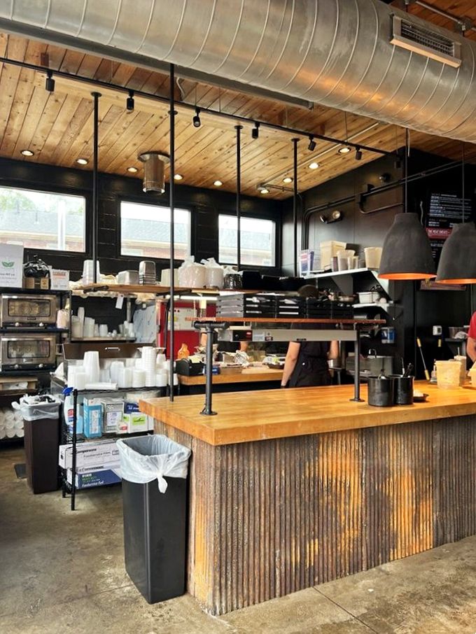 Inside Ray Ray's, function meets flavor with a rustic industrial vibe&mdash;wooden ceilings, corrugated metal, and the promise of barbecue magic.