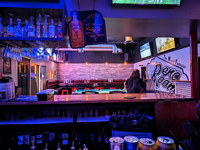 Blue-lit bottles and that neon sign create the perfect mood lighting—just dim enough for romance, bright enough to see your drink.