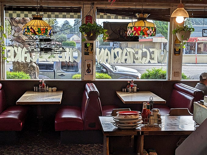 Tiffany-style lamps cast a warm glow over burgundy booths where countless conversations and comfort meals have unfolded.