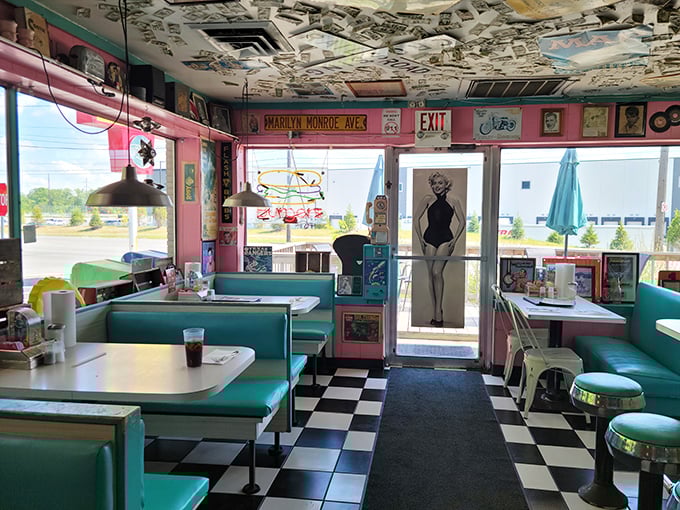 Step inside and the decades melt away—turquoise booths, checkered floors, and album-covered ceilings transport you to a time when Elvis was king and milkshakes were medicine.