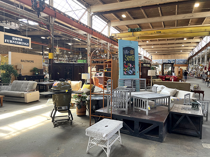 Sunlight streams through industrial windows, illuminating a furniture playground where mid-century meets Victorian in delightful disarray.