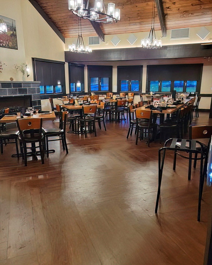Wooden beams stretch across the ceiling like a rustic cathedral dedicated to the worship of perfectly cooked proteins. The dining room awaits its faithful congregation.