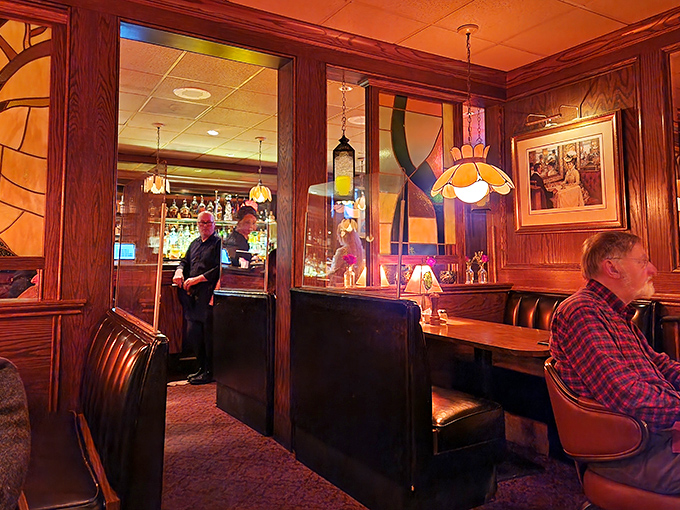 Rich wood paneling and amber lighting create that perfect old-school steakhouse vibe where Frank Sinatra wouldn't look out of place ordering a Manhattan.