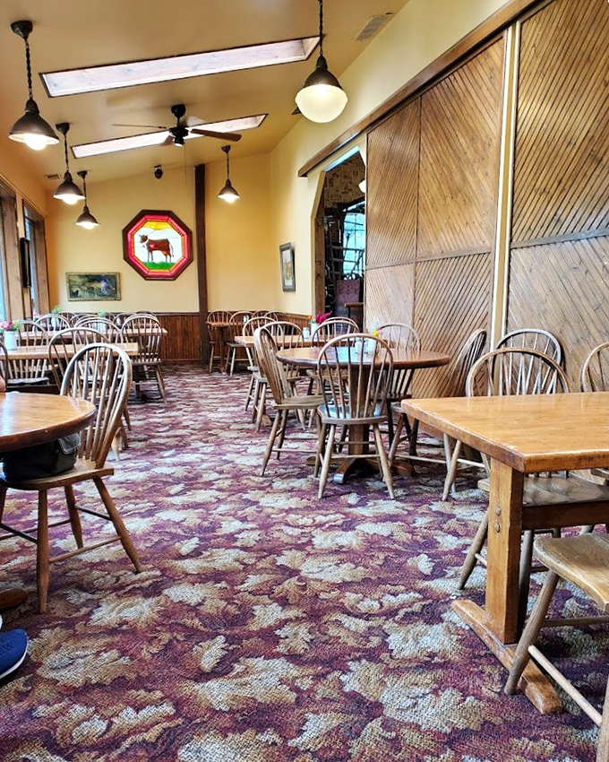 Rustic charm meets comfort in this dining area where wooden tables, Windsor chairs, and natural light create the perfect backdrop for memorable Pennsylvania meals.