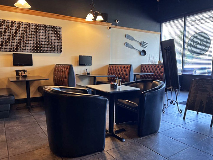 Leather booths and oversized cutlery artwork create an atmosphere that says, "We take comfort seriously here"&mdash;both in seating and the food that's about to arrive.