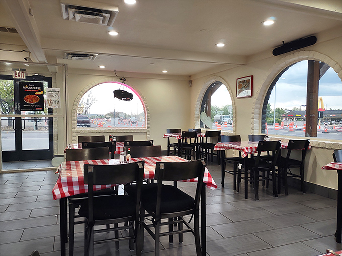 Red and white checkered tablecloths under arched windows create that "Nonna might appear any minute" vibe that perfect comfort food deserves.