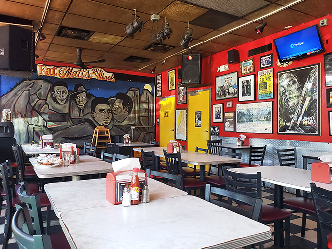 Blues legends watch over diners from vibrant murals, creating the perfect backdrop for that magical marriage of live music and slow-cooked meat.
