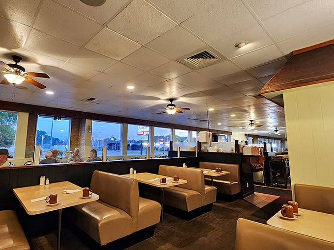 Classic diner booths in butterscotch tones create the perfect backdrop for breakfast conversations that flow as freely as the coffee.