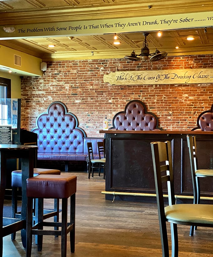 Exposed brick walls and tufted booths create the perfect backdrop for witty wall quotes that remind you life's too short for mediocre meals or boring company.