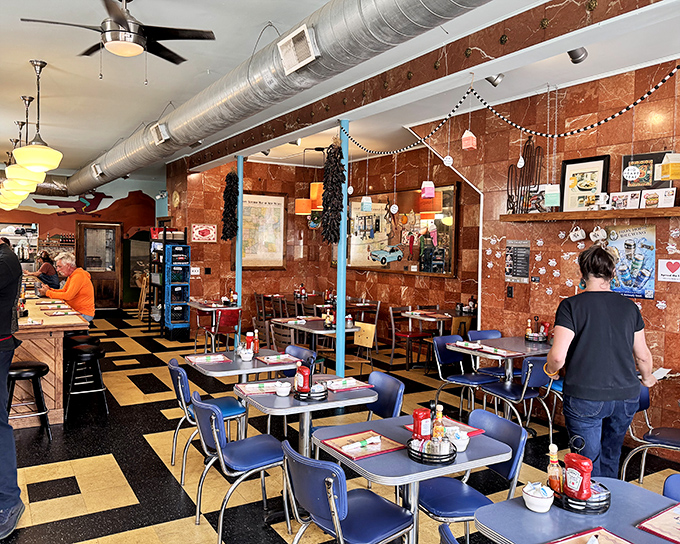 Step inside and the copper-toned walls, checkerboard floor, and blue retro chairs transport you to a time when breakfast was the most important diplomatic mission of the day.