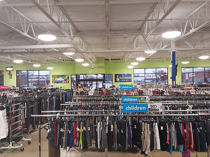 Endless racks stretch toward retail infinity under bright lights and lime green walls&mdash;the Narnia of secondhand shopping awaits.