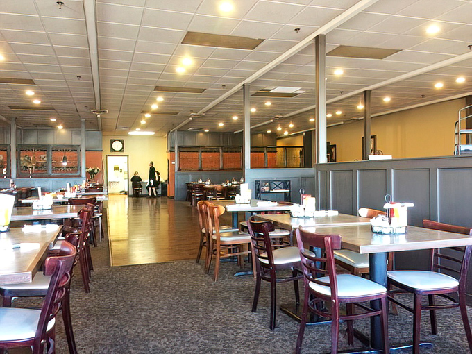 Inside, the spacious dining room offers comfort without pretension. Those burgundy chairs have supported countless happy diners through years of memorable meals.