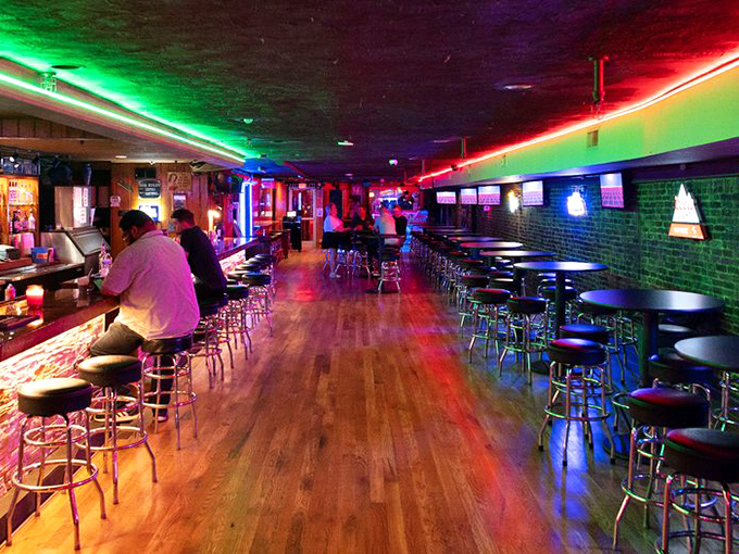 Neon lights cast a colorful glow across wooden floors and bar stools. The perfect setting for pints and conversation away from Broadway's twangy chaos.