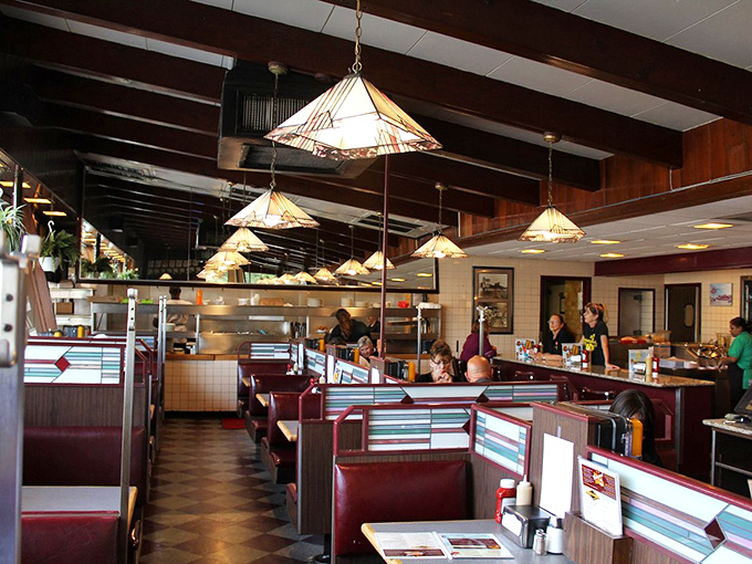 Red vinyl booths and warm pendant lighting create the perfect time capsule where calories don't count and conversations flow as freely as the coffee refills.