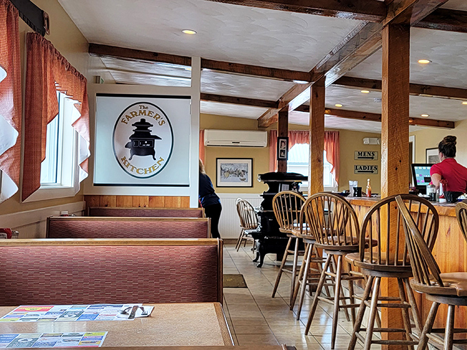 Wooden beams, country curtains, and classic Windsor chairs—this isn't designer farmhouse chic, folks. It's the real New England deal.