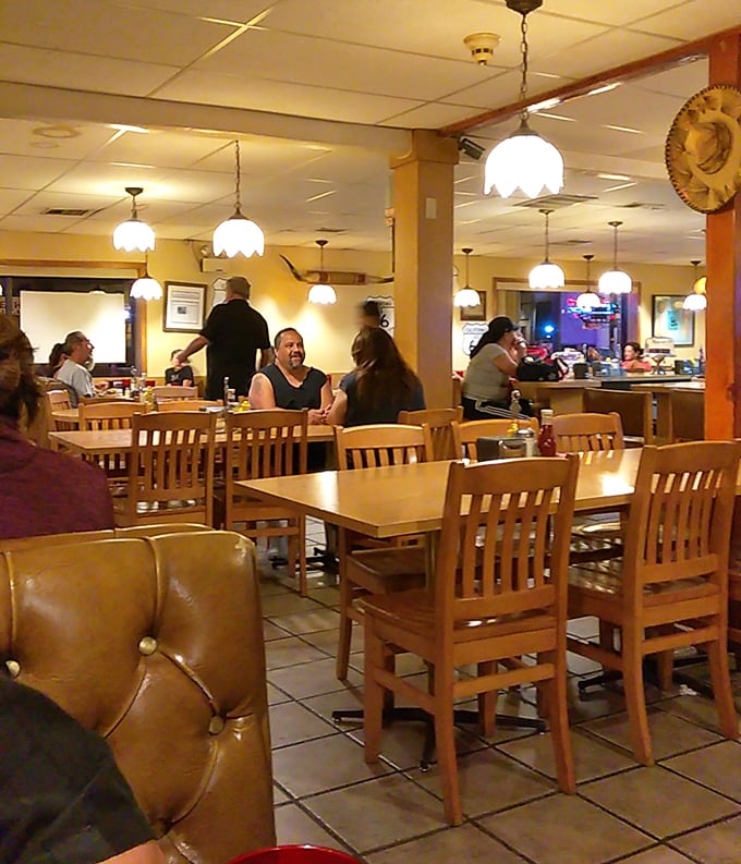Pendant lights cast a warm glow over wooden tables where decades of conversations have unfolded&mdash;this isn't trendy ambiance, it's authentic New Mexico dining history.