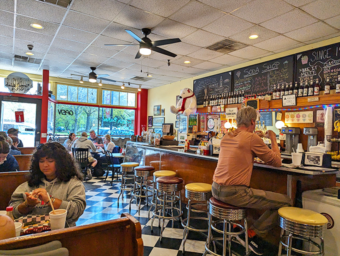 Inside, the classic black and white checkered floor sets the stage for a timeless American experience where memories are made between bites.