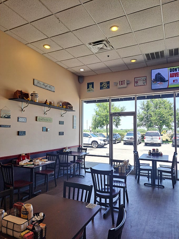 Sunlight streams through large windows, illuminating a cozy dining space where comfort meets simplicity&mdash;the stage is set for memorable meals.