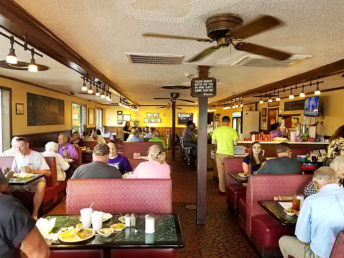 Welcome to the time capsule of taste. Red vinyl booths, yellow walls, and ceiling fans create the perfect backdrop for conversations over comfort food.