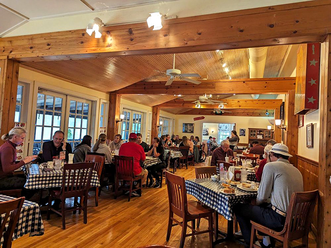 Knotty pine walls and blue-checked tablecloths set the scene for Southern comfort food paradise. The bustling dining room hums with the satisfaction of well-fed patrons.