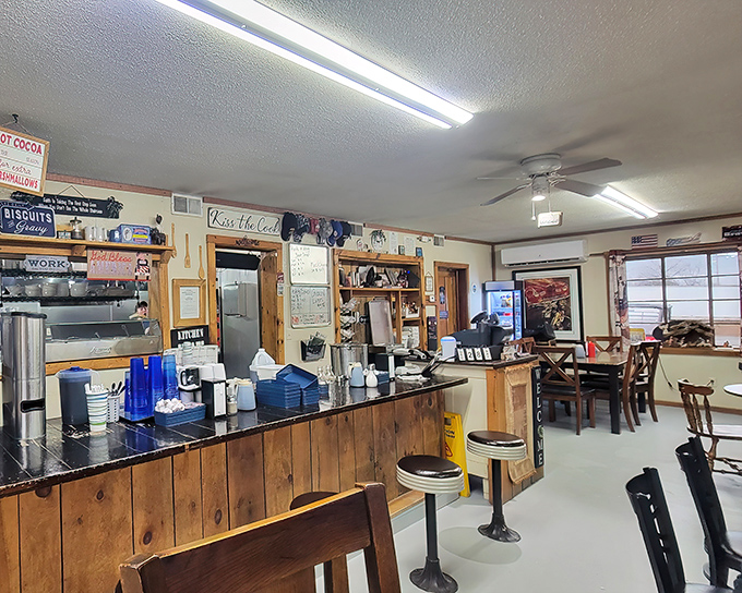Inside, rustic wooden paneling and counter seating create that perfect small-town diner atmosphere where conversations flow as freely as the coffee.