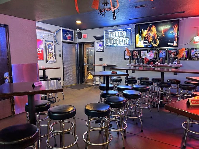 Classic bar ambiance done right&mdash;dim lighting, chrome barstools, and neon beer signs create that "I've found my new favorite spot" feeling.