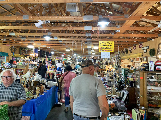 Beneath rustic wooden beams, browsers hunt for treasures while vendors stand guard over collections curated with decades of passionate expertise.