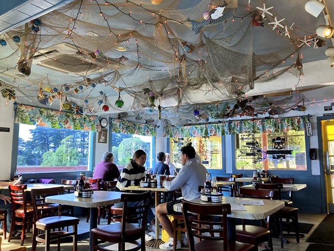 Fishing nets and colorful buoys dangle from the ceiling, creating the perfect maritime atmosphere for devouring creatures from the deep.
