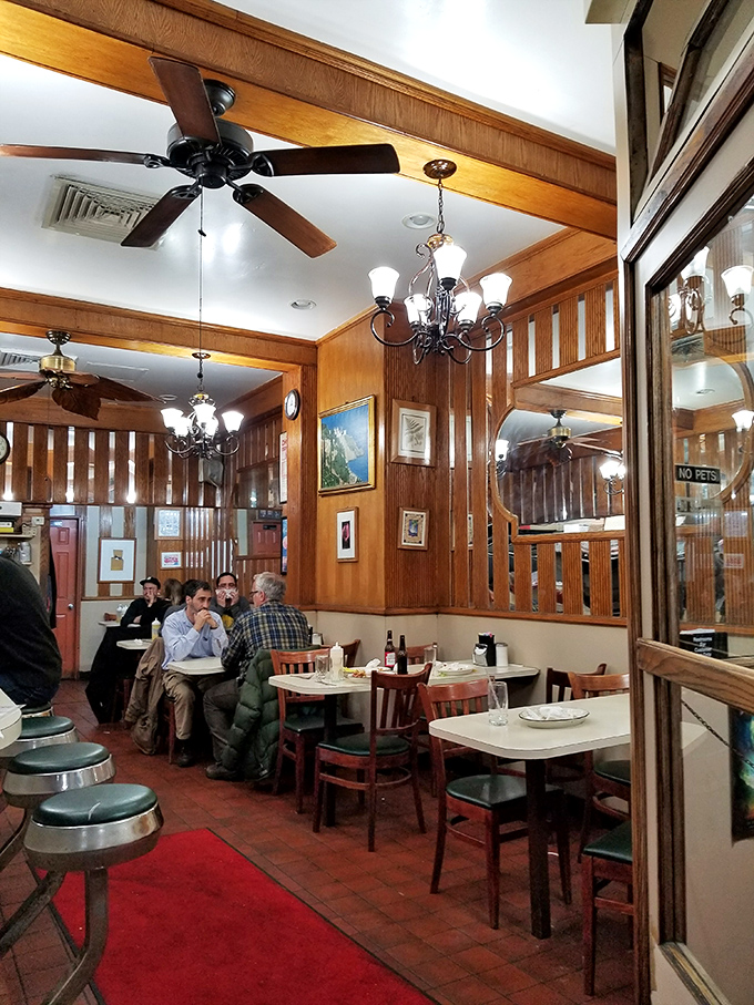 Wood-paneled walls, ceiling fans, and cozy booths create that timeless diner atmosphere where conversations flow as freely as the coffee refills.